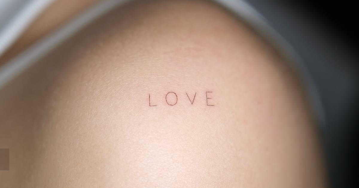 Lettering tattoo of the word "love" handwritten on the