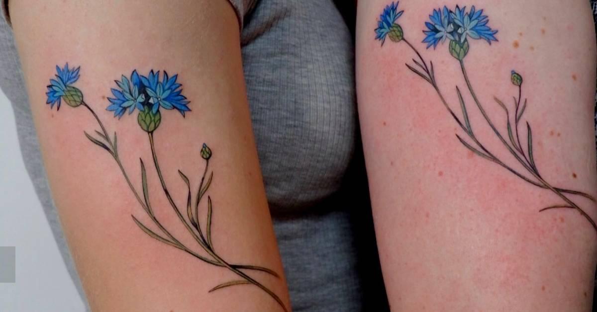 Matching cornflower tattoo for mother and daughter.