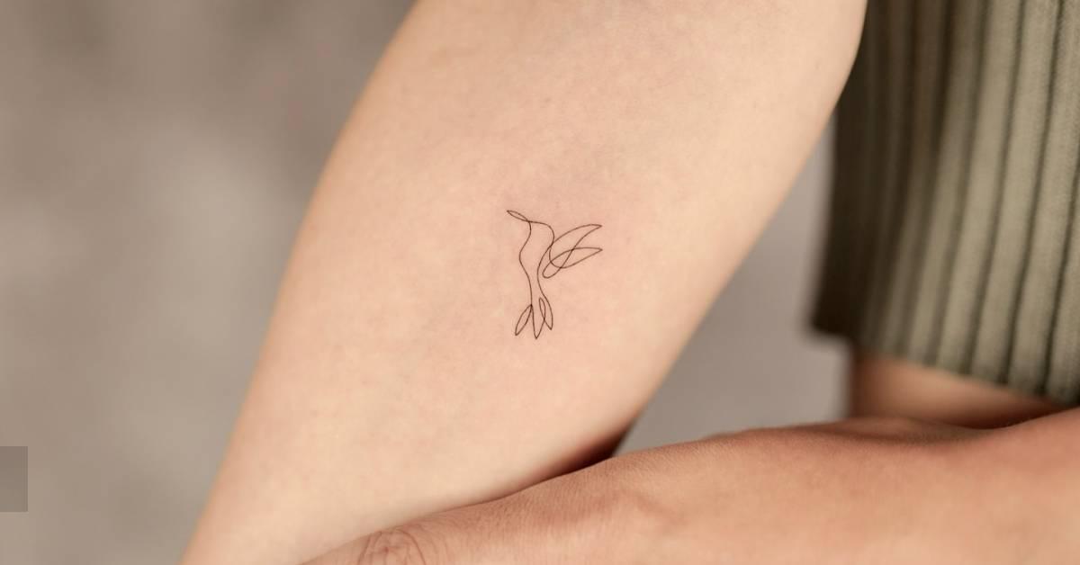 One line hummingbird tattoo located on the inner