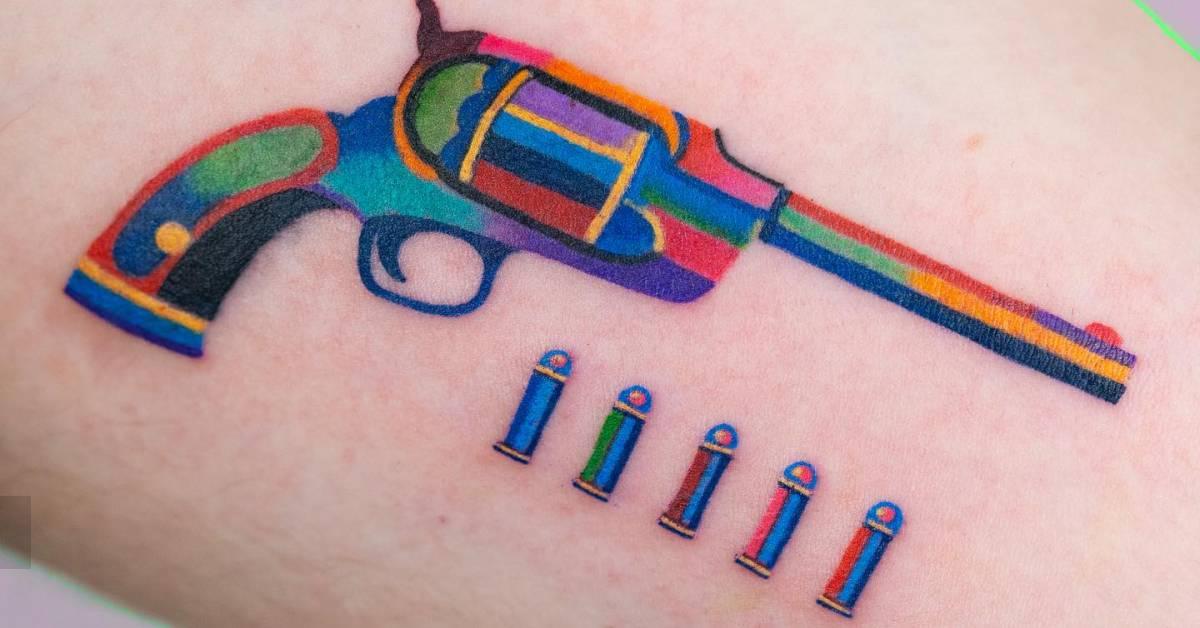 Revolver tattoo located on the inner arm, illustrative