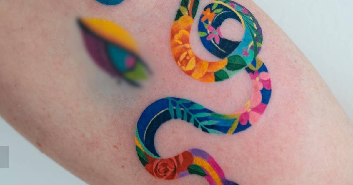 Snake tattoo in watercolor style located on the inner