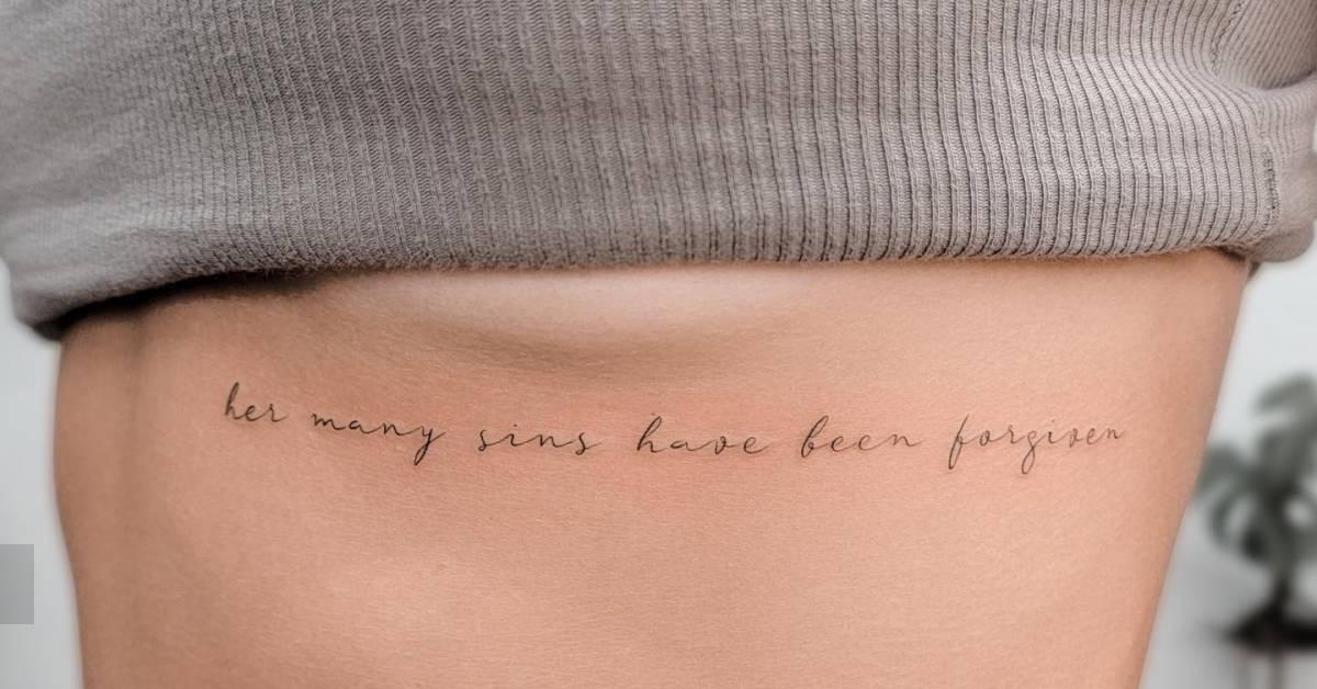 "Her many sins have been forgiven" lettering tattoo
