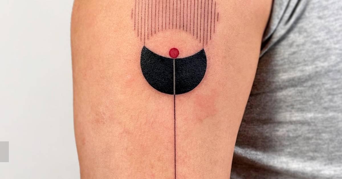 Abstract geometric tattoo located on the upper arm.