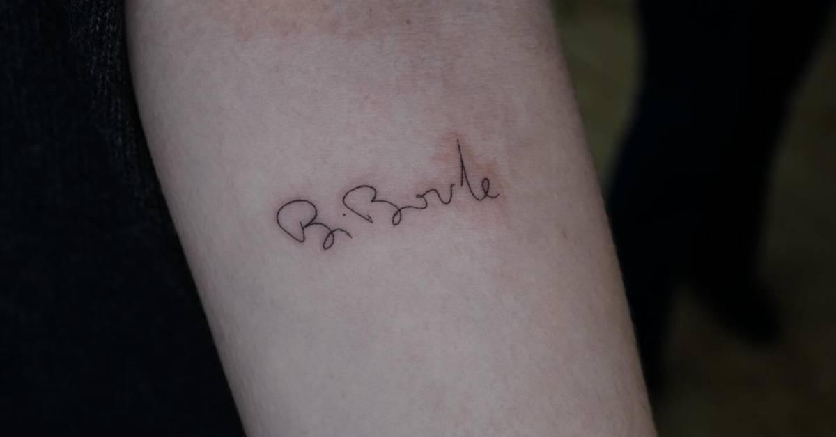 Signature tattoo located on the inner forearm.