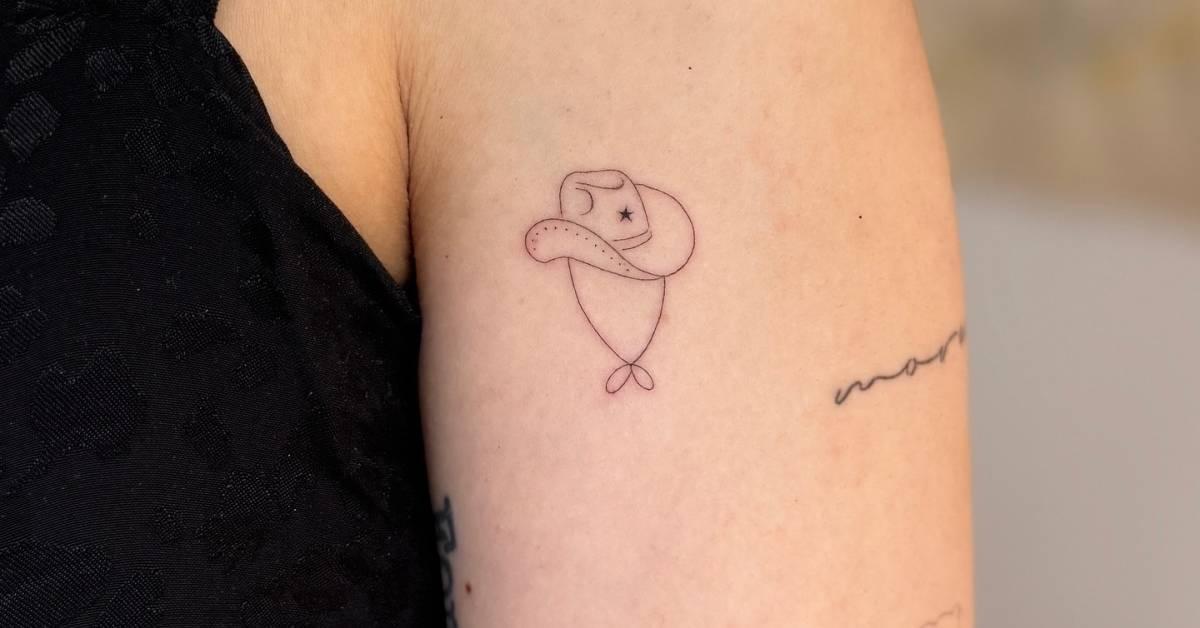 Cowboy hat tattoo in fine line style done on the upper