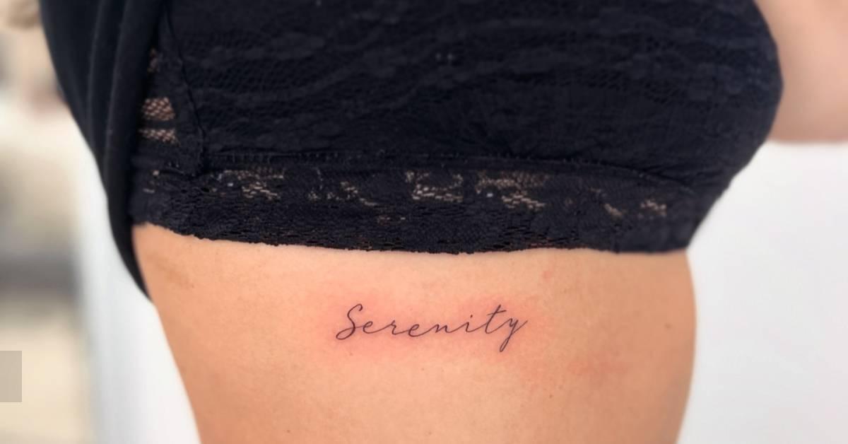 Lettering tattoo of the word "serenity" located on the