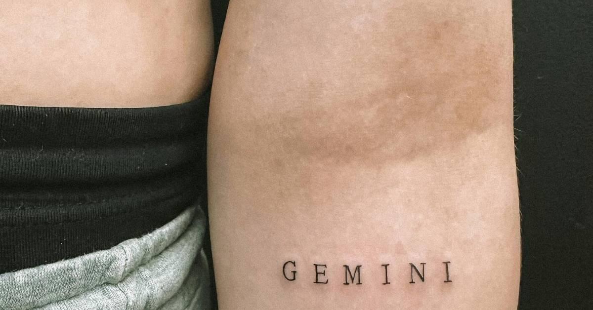 "Gemini" lettering tattoo located on the inner forearm.