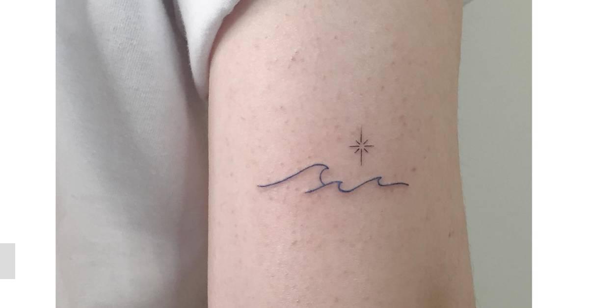 Minimalistic wave and star tattoo placed on the tricep.