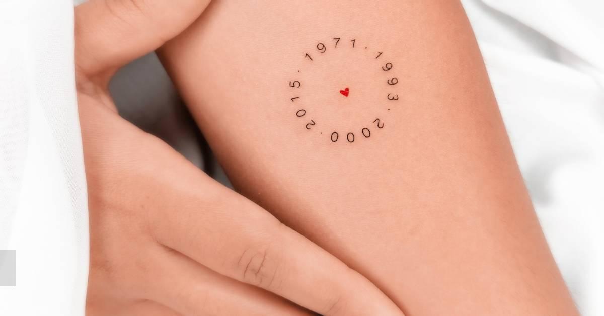 Birth years lettering tattoo placed on the inner