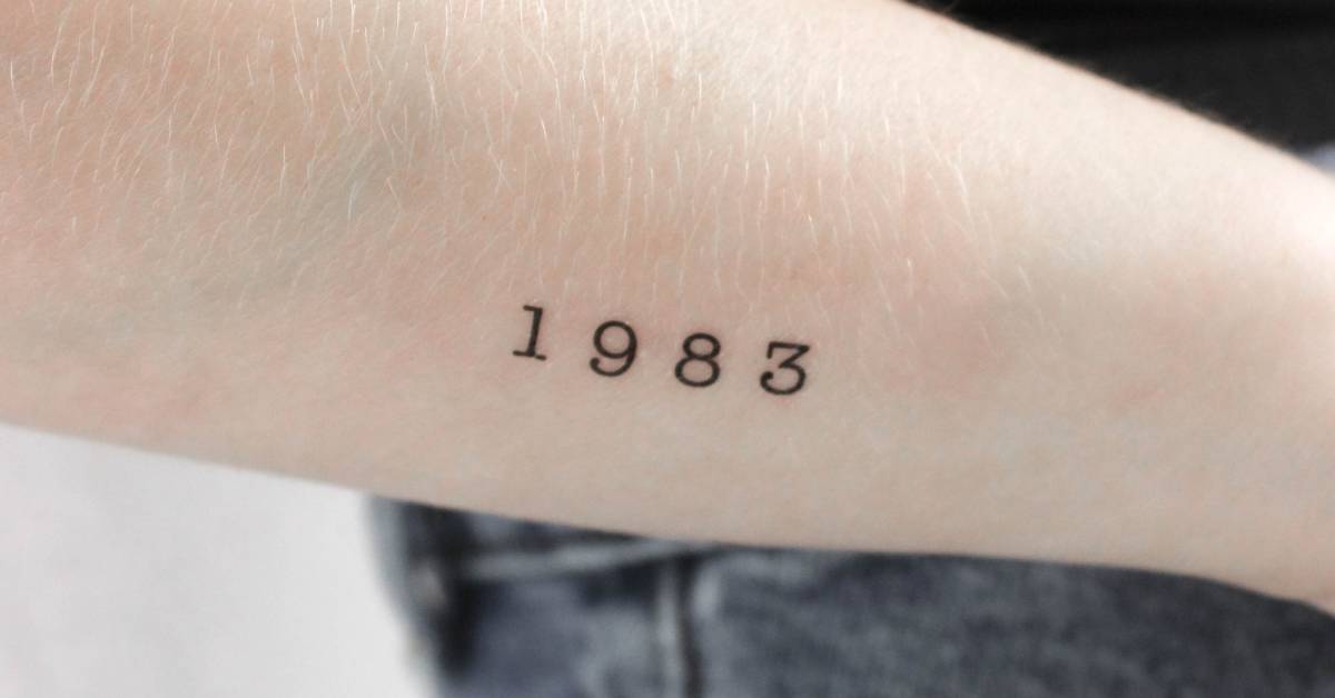 Birth year "1983" temporary lettering tattoo located on