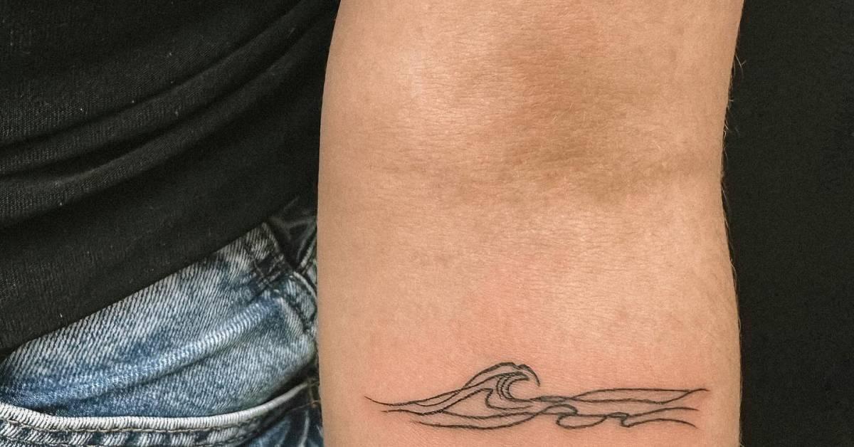 Waves tattoo in fine line style done on the inner