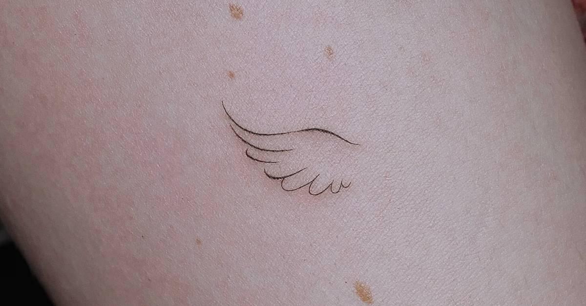 Minimalistic style wing tattoo located on the upper