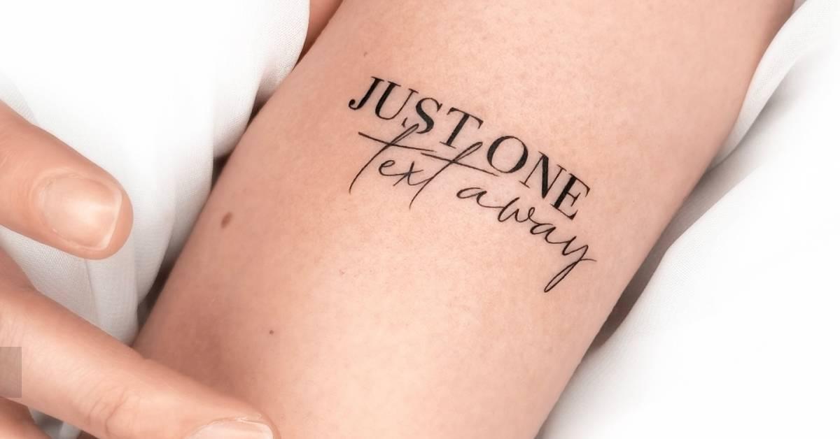 "Just one text away" lettering tattoo located on the