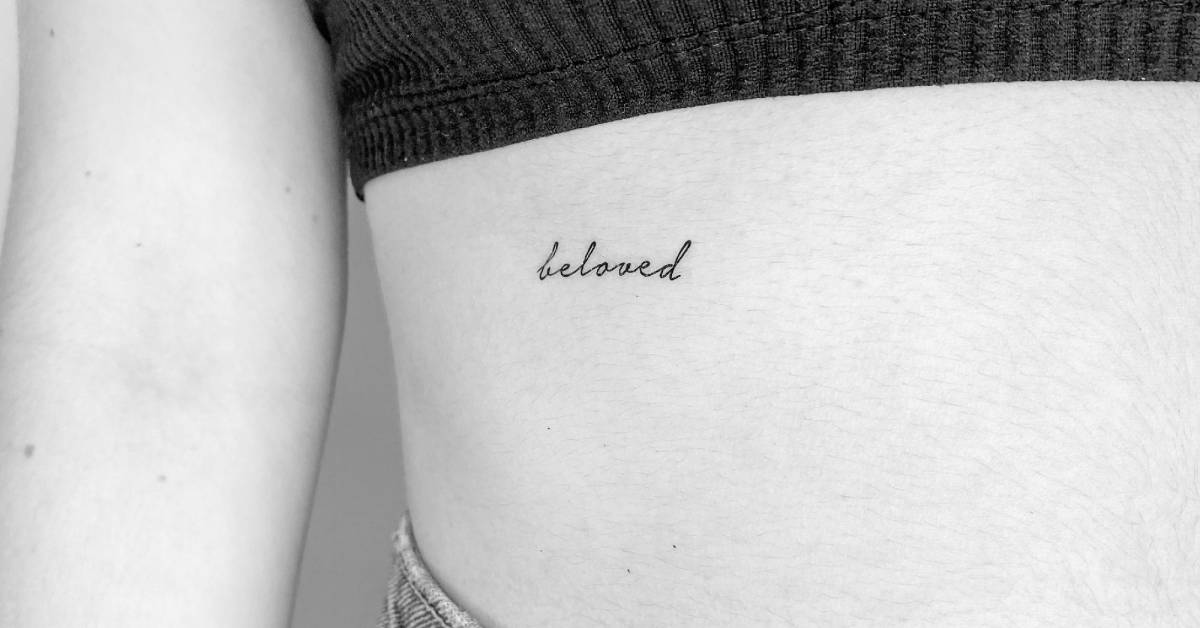 Word "beloved" temporary lettering tattoo located on