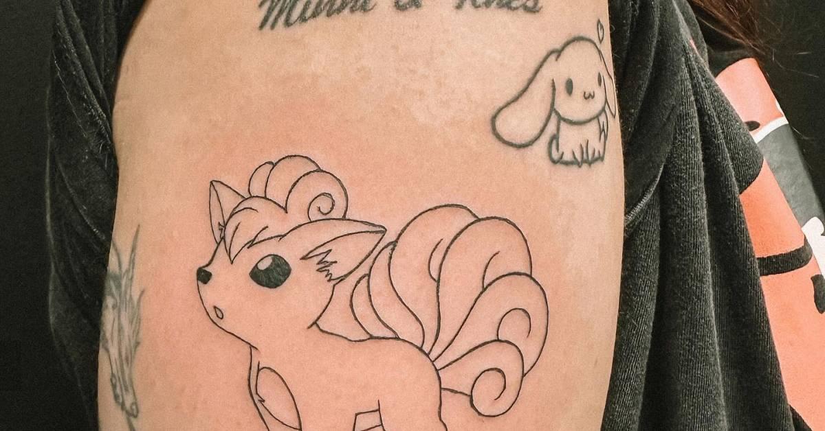 Cartoon style Vulpix tattoo placed on the upper arm.