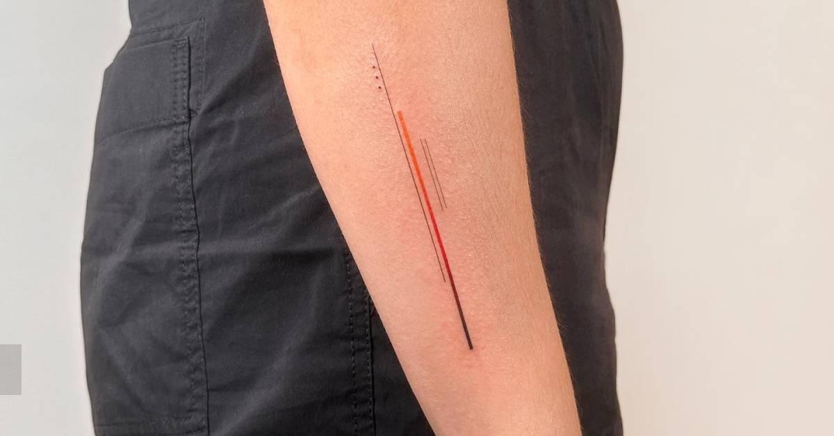 Spectrum lines tattooed on the forearm.