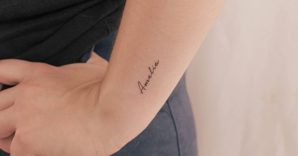 "Amelia" temporary lettering tattoo located on the