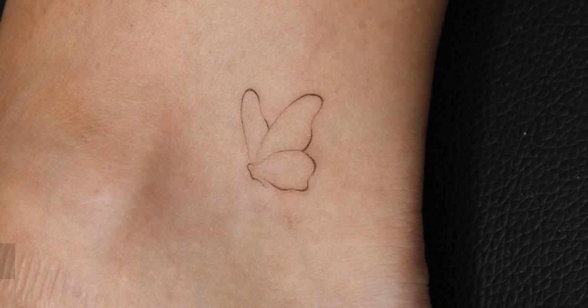 Minimalistic butterfly tattoo in fine line style