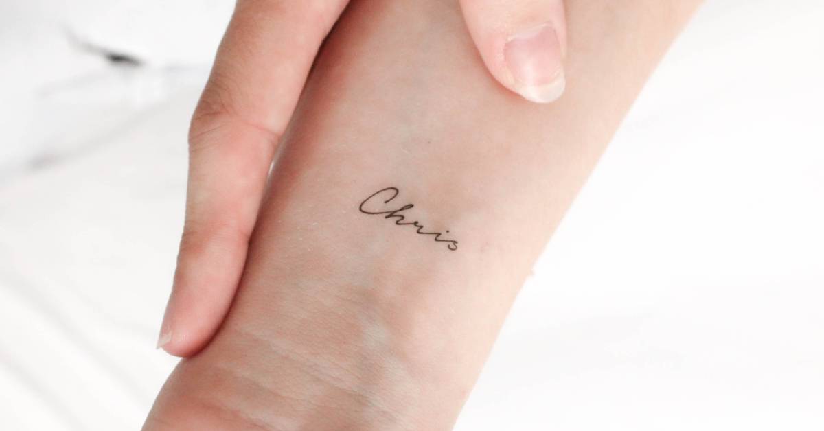 Name "Chris" temporary lettering tattoo located on the