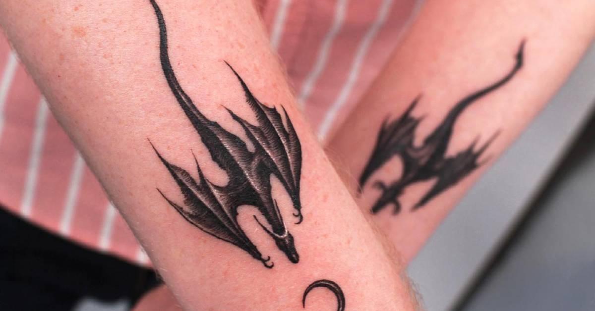 Individual matching dragons tattooed on the forearms.