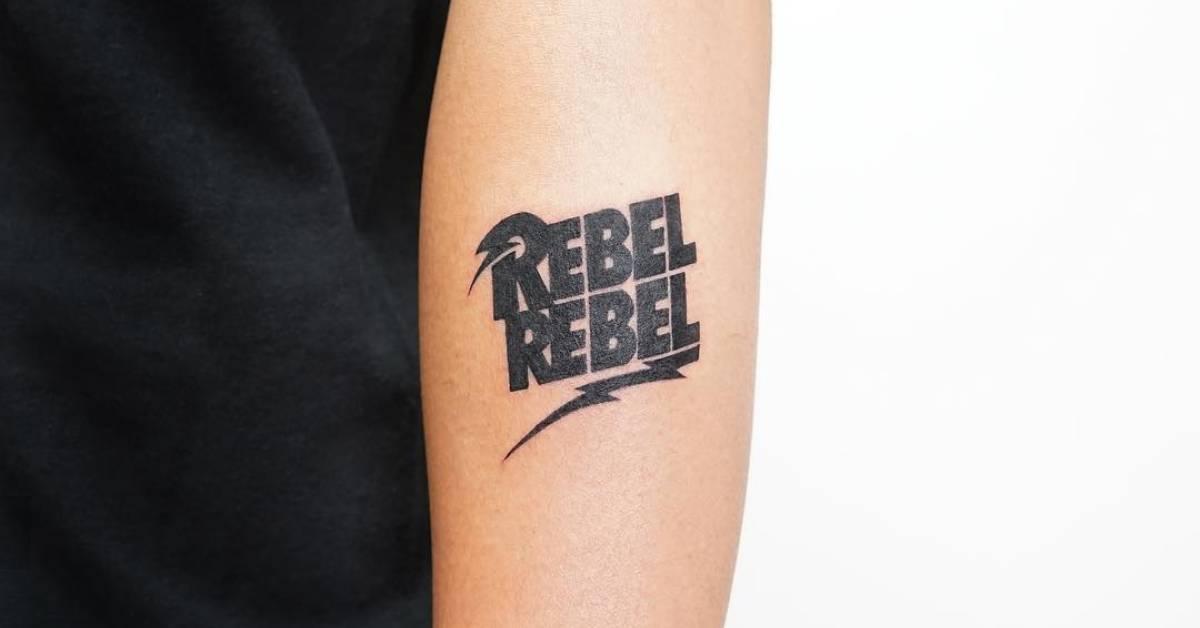 "Rebel Rebel" tattoo located on the forearm.