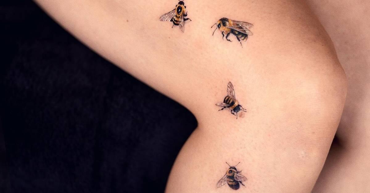 Micro-realistic style bees tattooed on the leg.