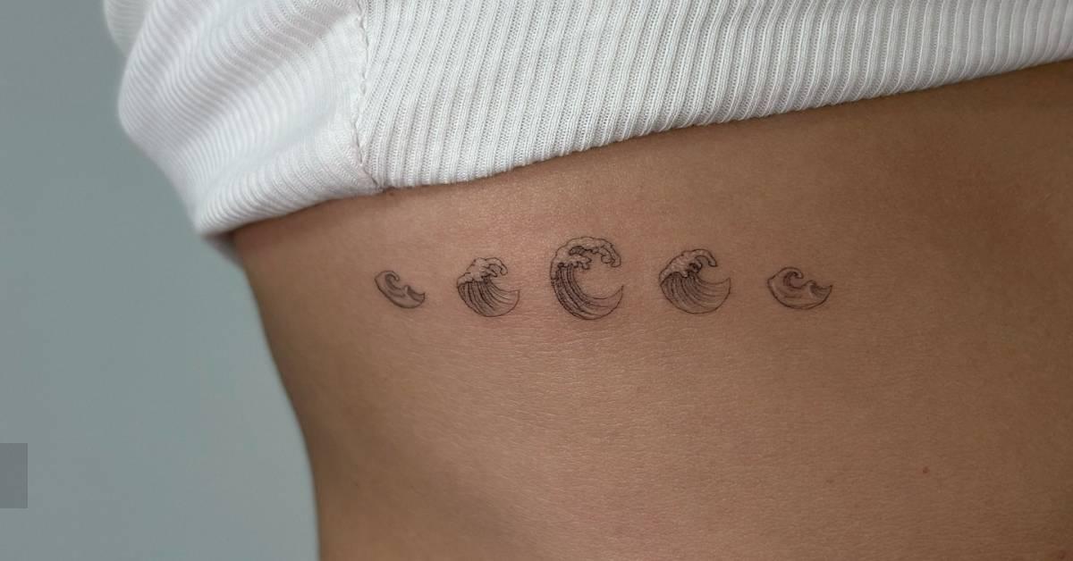 Single needle waves tattoo located on the rib.