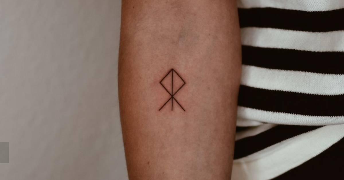 Rune tattoo located on the inner forearm, minimalistic