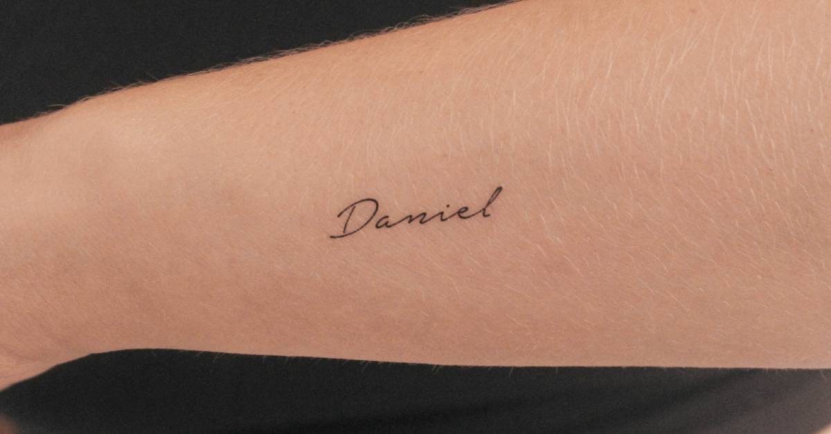Name "Daniel" temporary lettering tattoo located on the