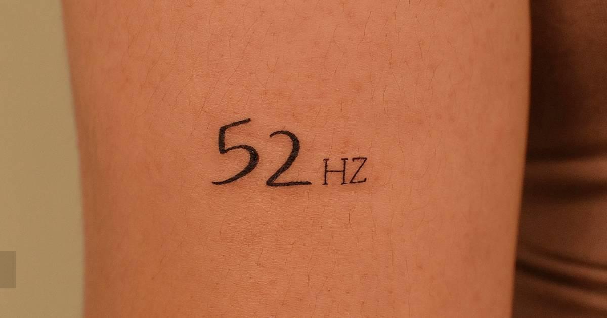 "52Hz" lettering tattoo located on the tricep.