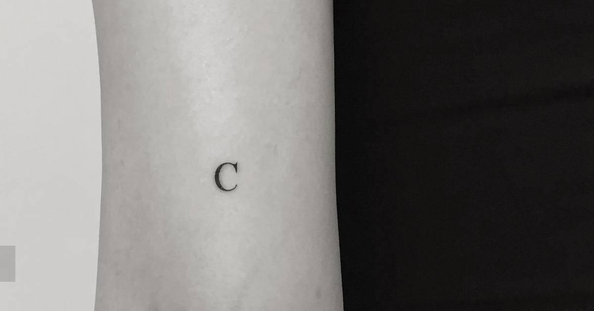 Minimalistic style letter "C" tatoo done on the tricep.