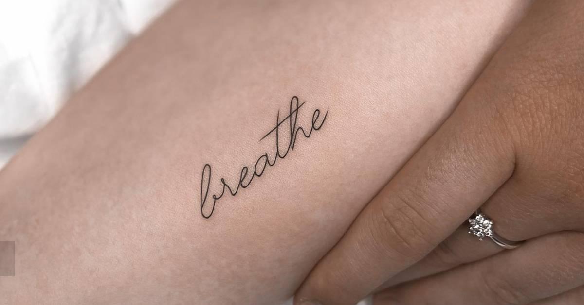 "Breathe" lettering tattoo handwritten on the inner