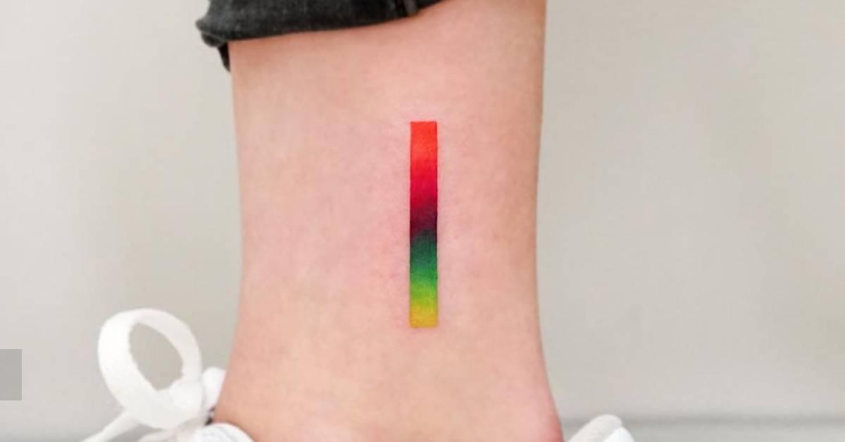Watercolor style spectrum tattoo located on the ankle.