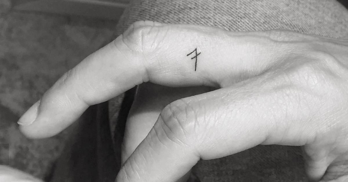 Little minimalistic tattoo of the number 7 placed on