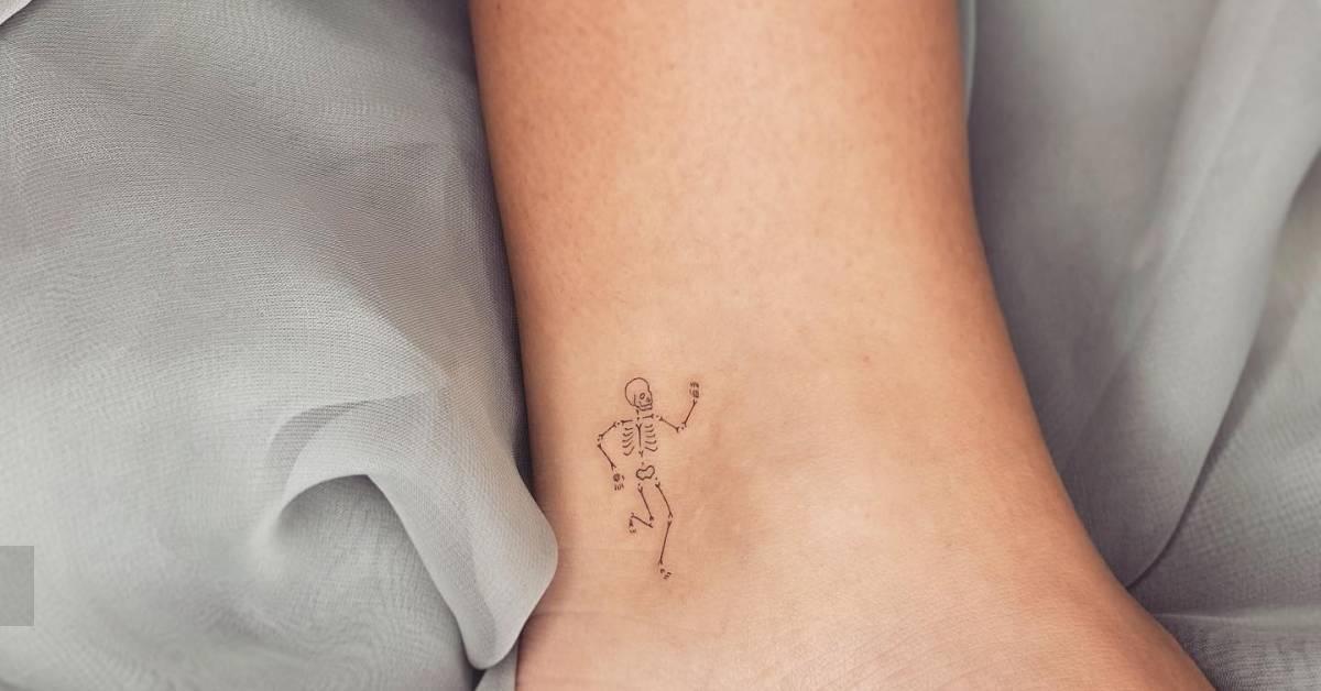 Fine line style dancing skeleton tattoo placed on the