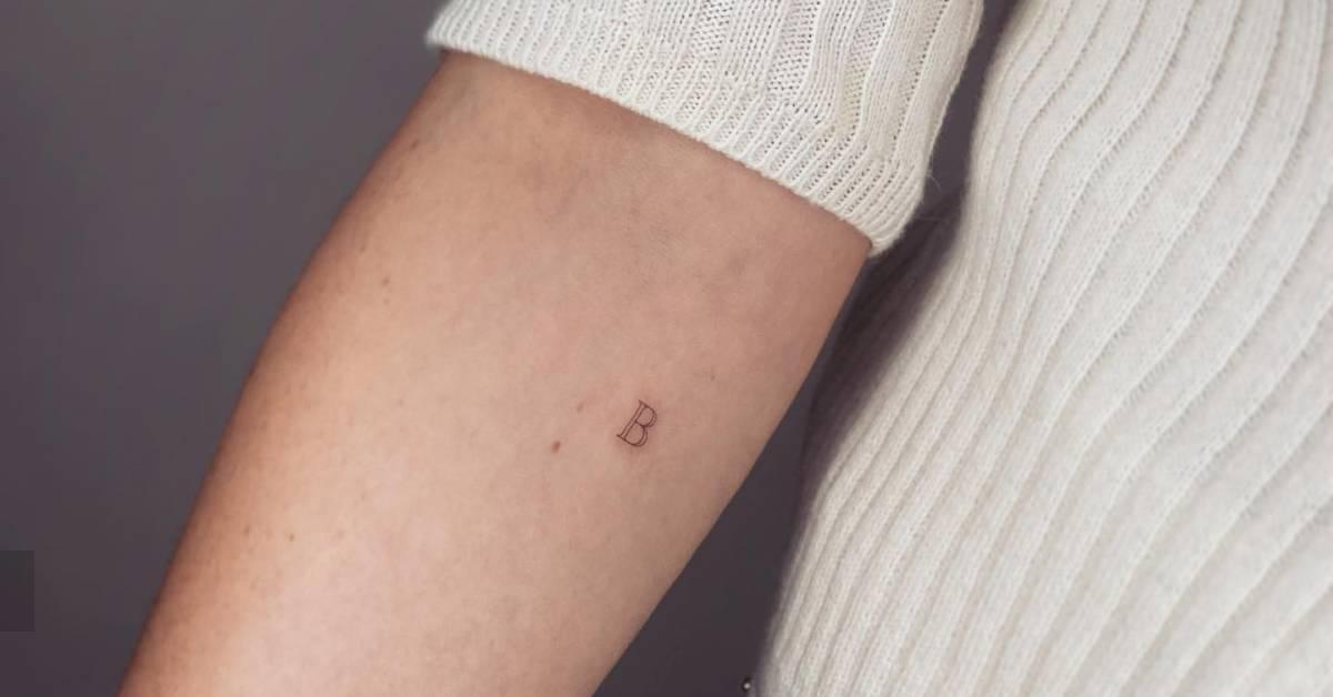 Minimalistic letter "B" tattoo placed on the inner
