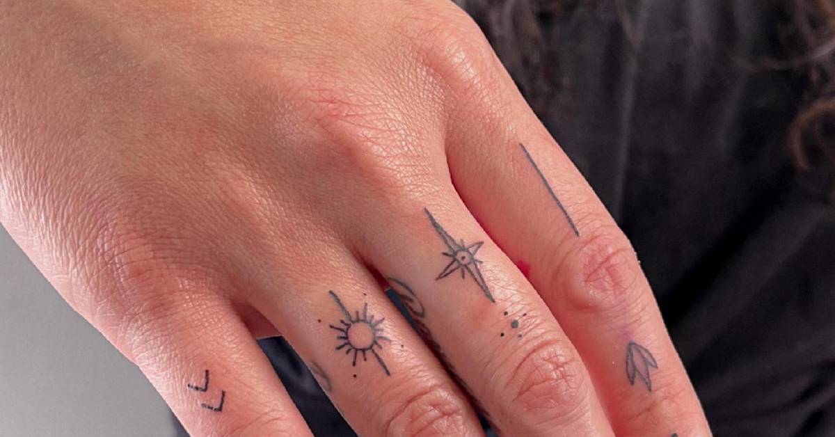 Fine line style finger composition tattoos.