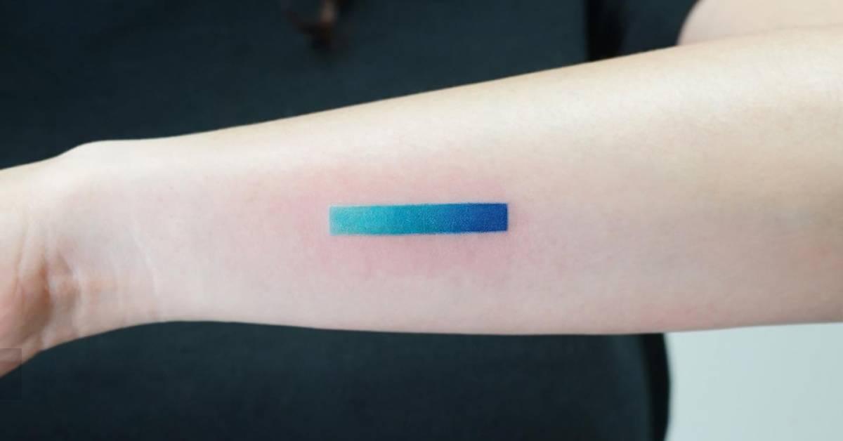 Small blue spectrum tattoo located on the wrist.