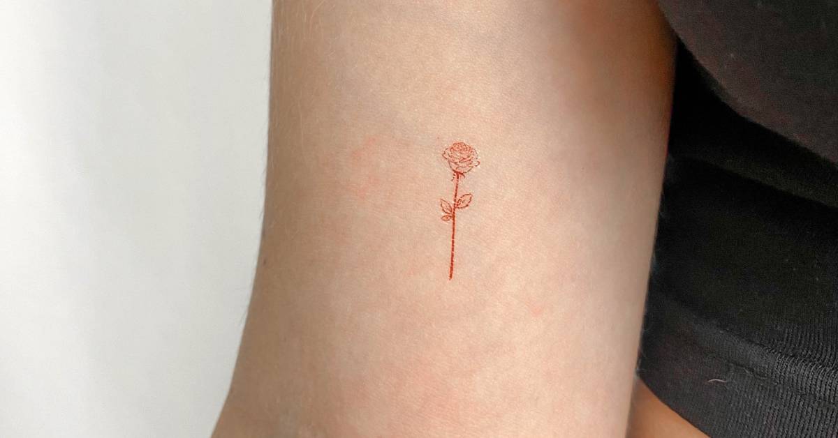 Fine line style red rose temporary tattoo located on
