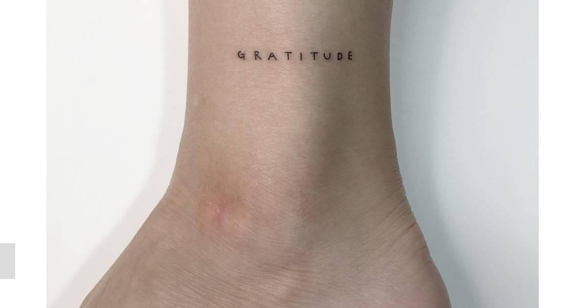 Lettering tattoo of the word "gratitude" located on the