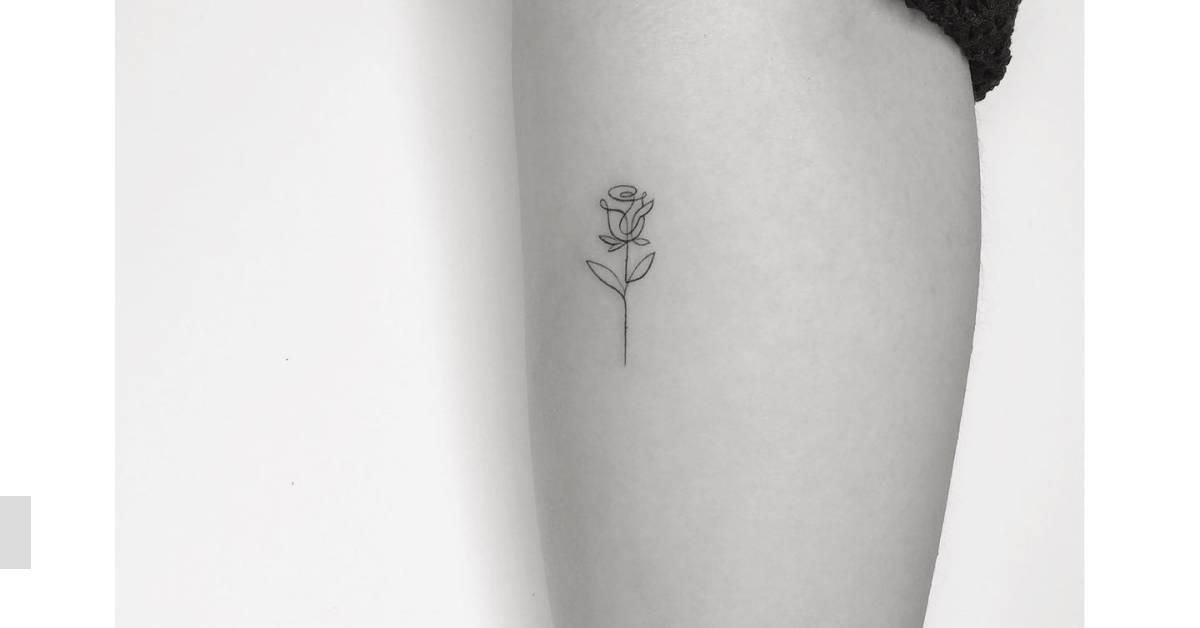 One line rose tattoo located on the inner forearm.
