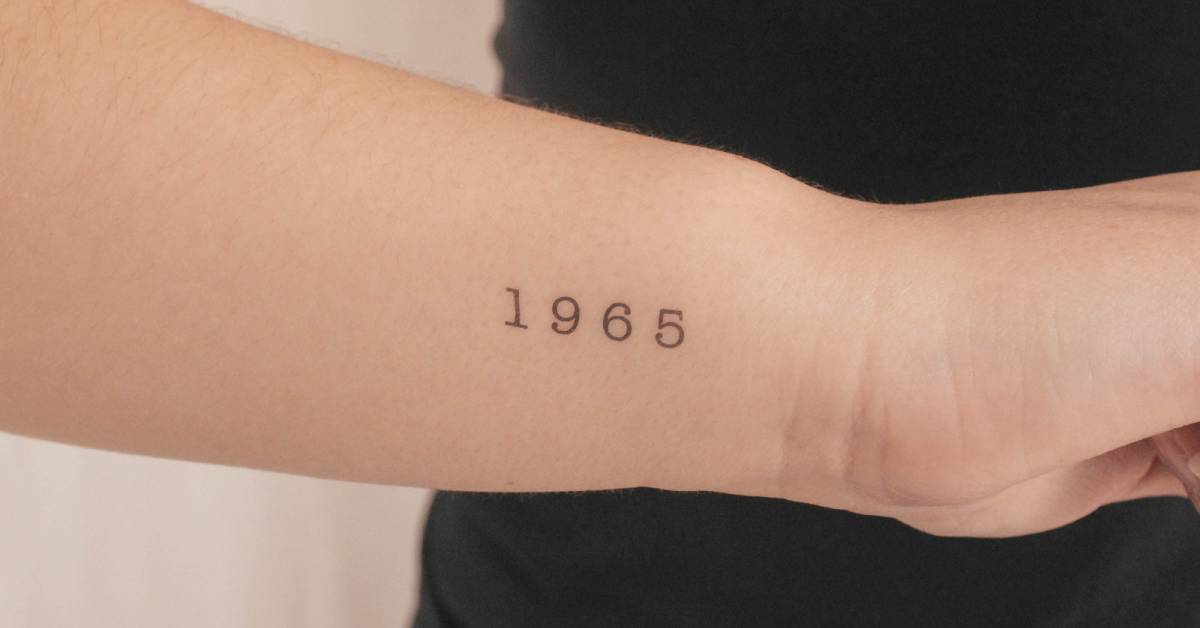 "1965" birth year temporary tattoo located on the