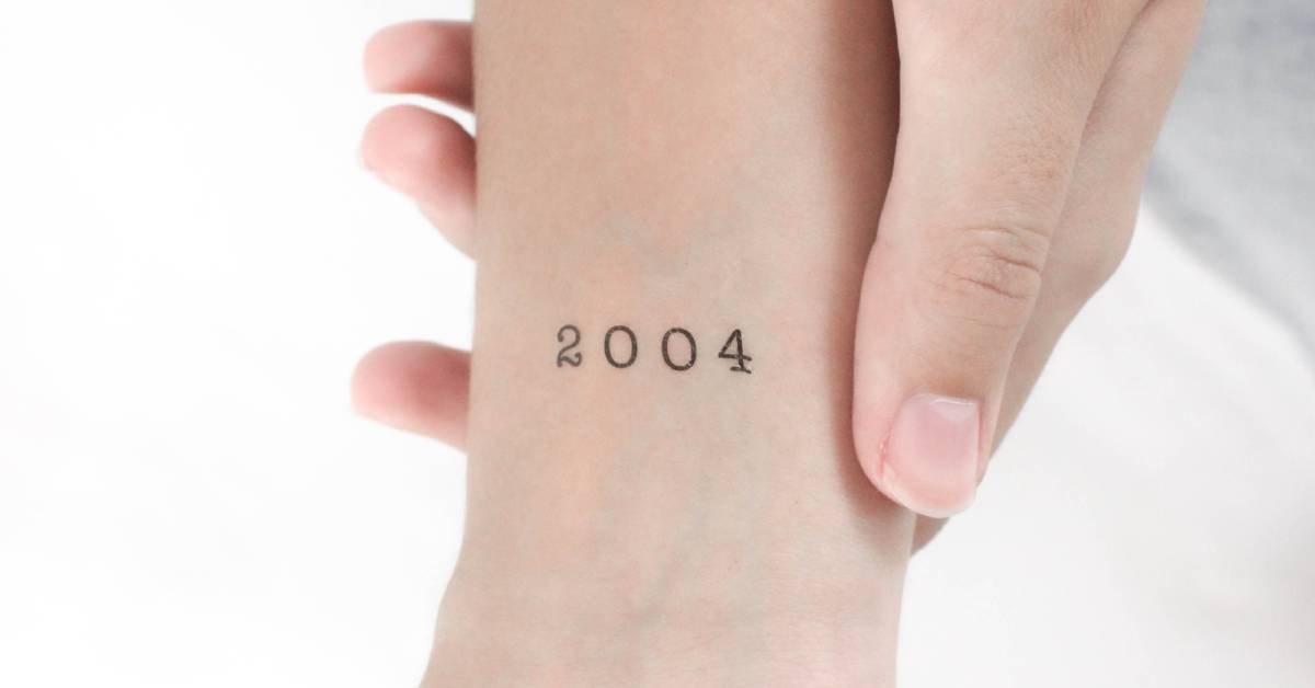 Birth year "2004" temporary lettering tattoo located on