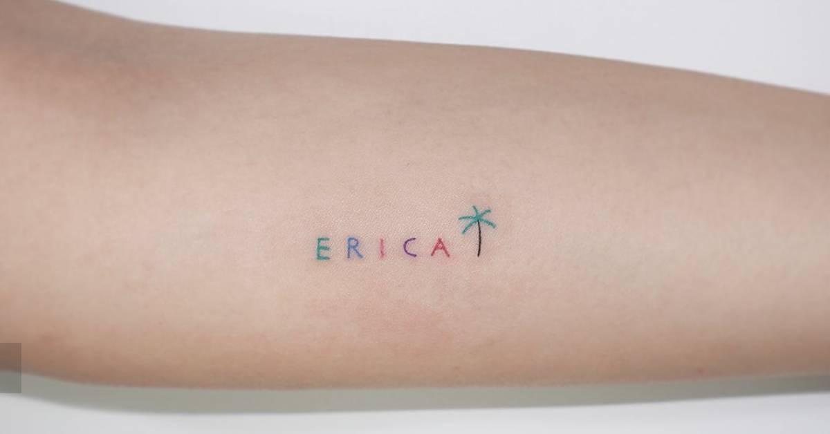 "Erica" lettering tattoo located on the inner forearm.