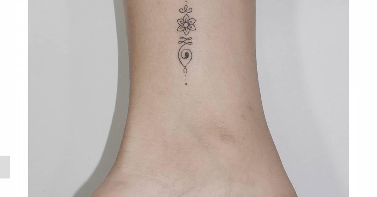 Flower unalome tattoo located on the ankle, fine line