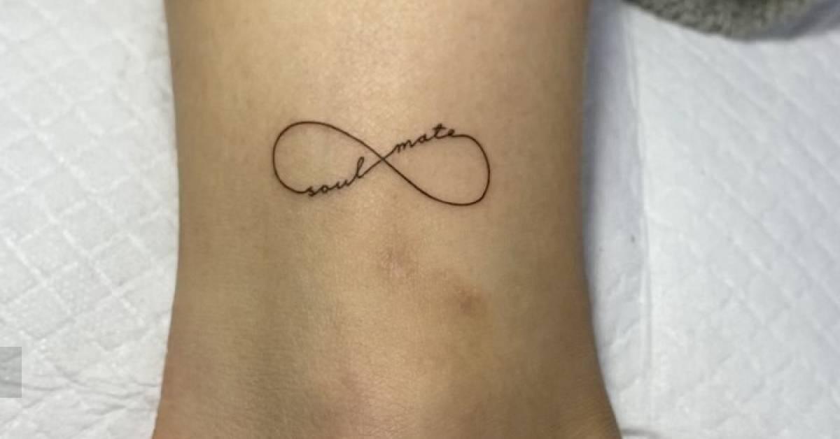 Fine line infinity symbol + "soul mate" tattoo located