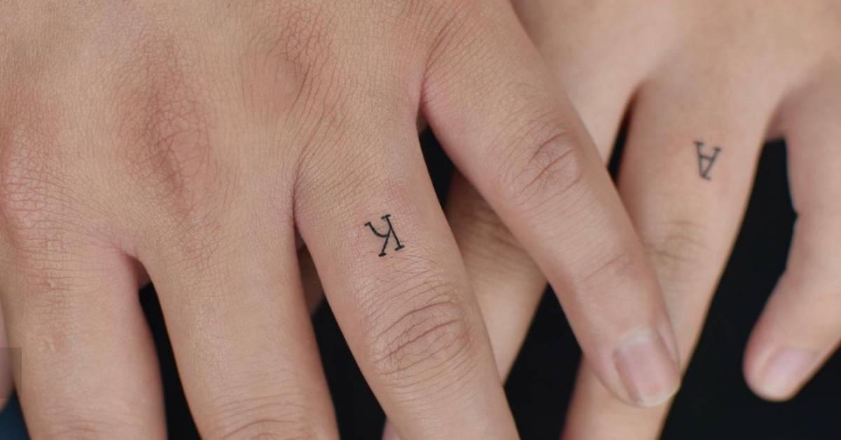 Matching initials tattoo for couple.