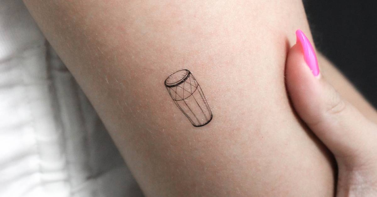 Fine line style bongo drum temporary tattoo located on