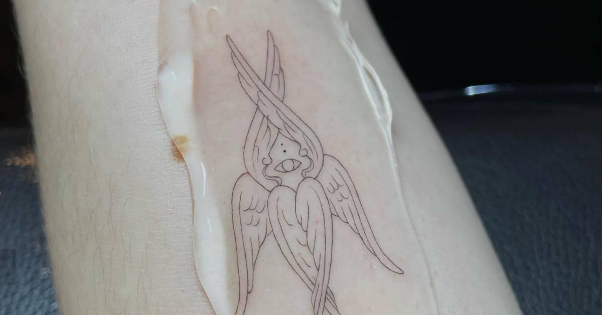 Fine line Six Winged Seraphim tattoo located on the