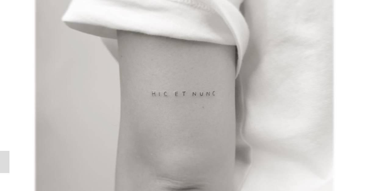 "Hic et nunc" lettering tattoo located on the tricep.
